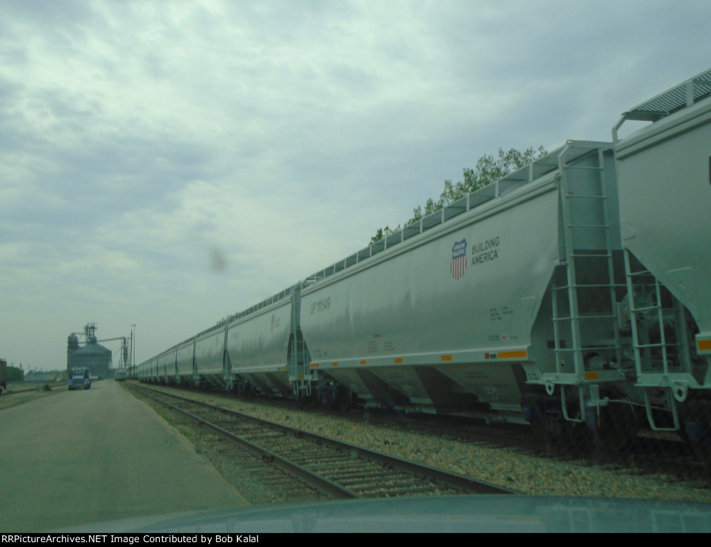 Heading West pass a string of new UP Hoppers